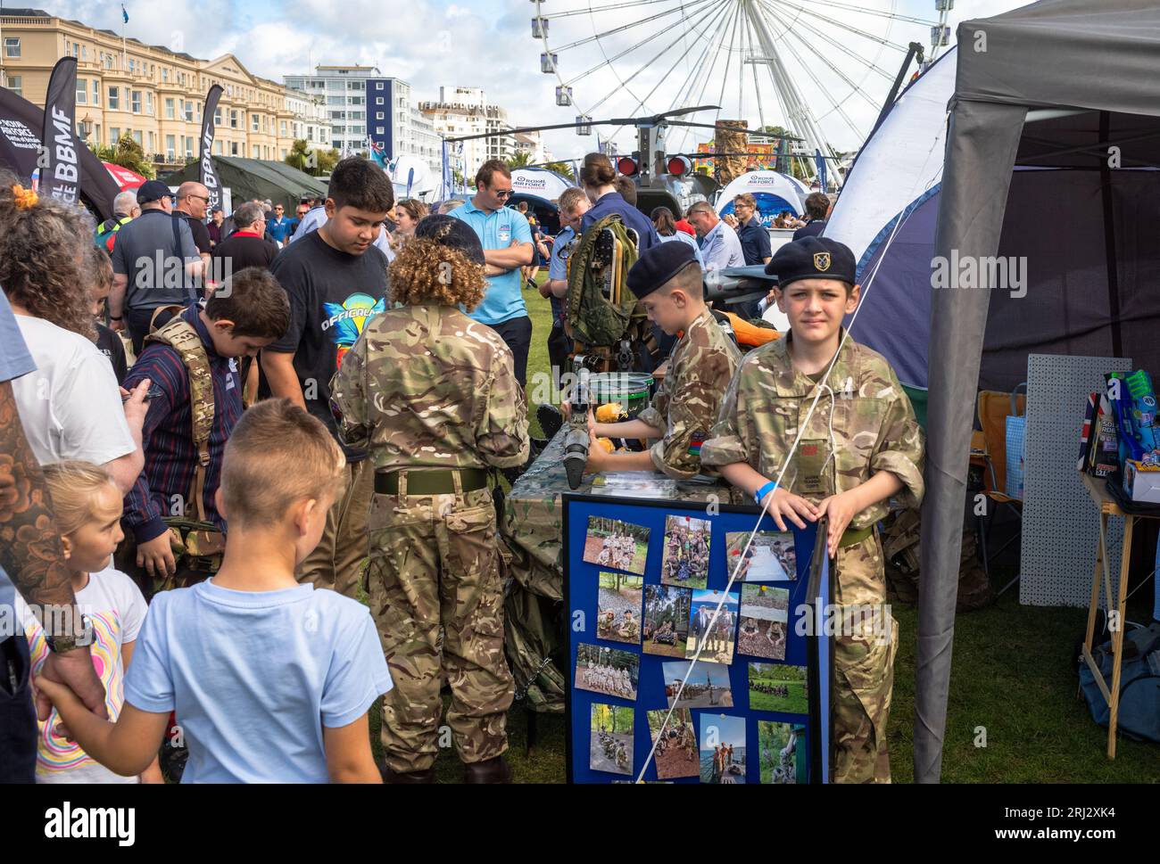 Young Army Cadets in military uniform at a display stand in the ...