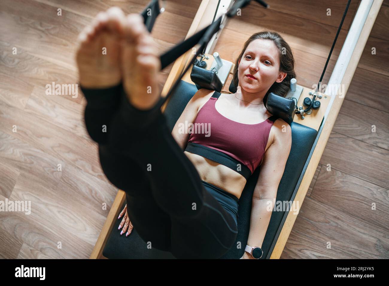 Beautiful fit-shape female dressed sporty doing ABS muscles strength ...