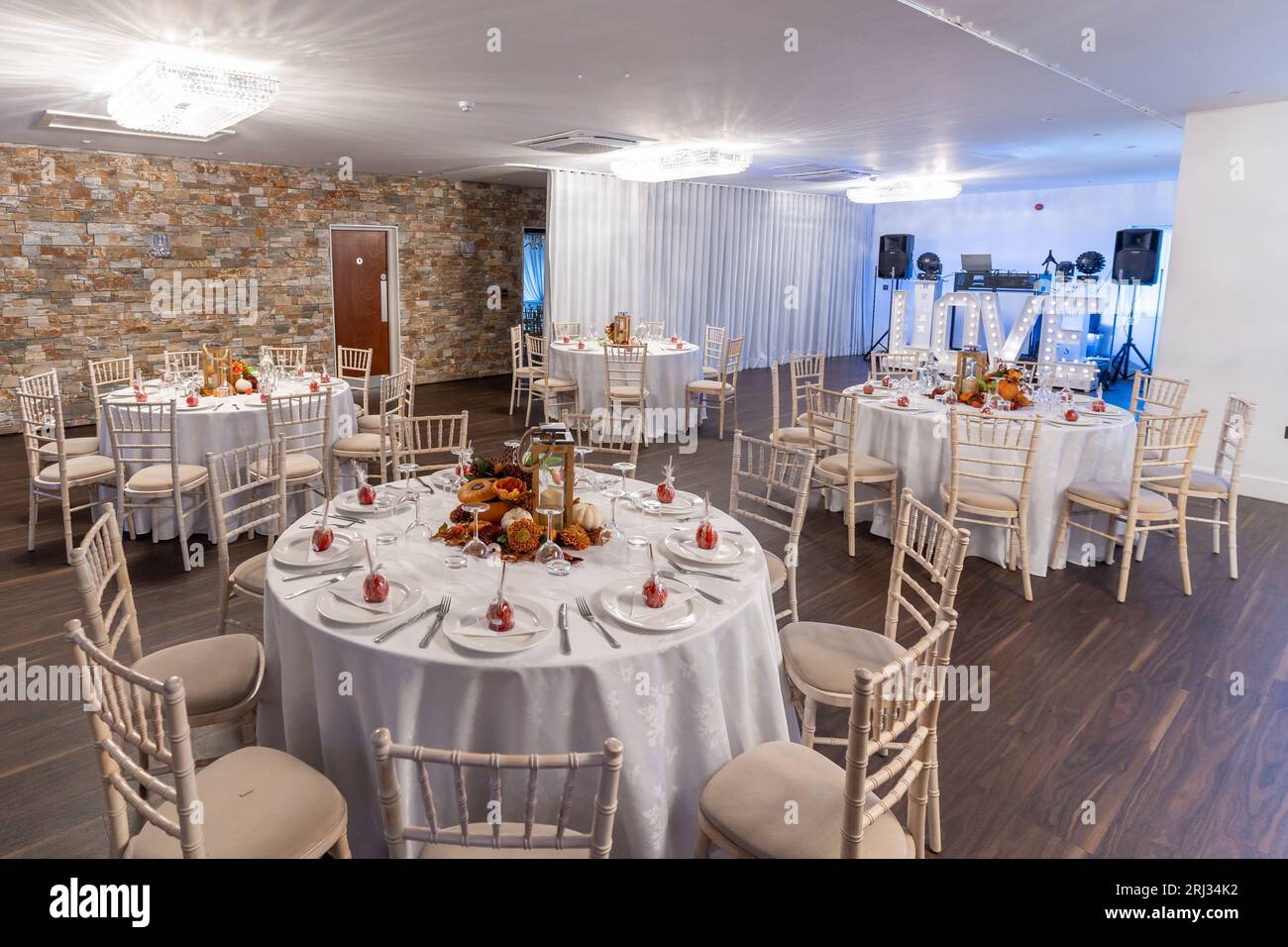 An empty wedding reception area set up with tables, ready for guests to ...