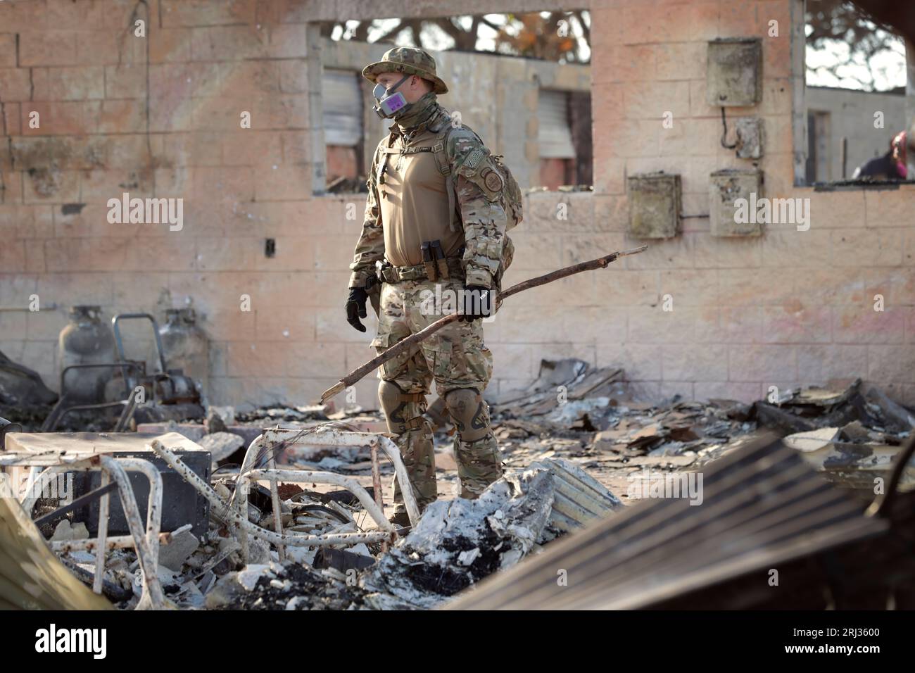A U.S. Border Patrol agent combs through a neighborhood destroyed by a ...