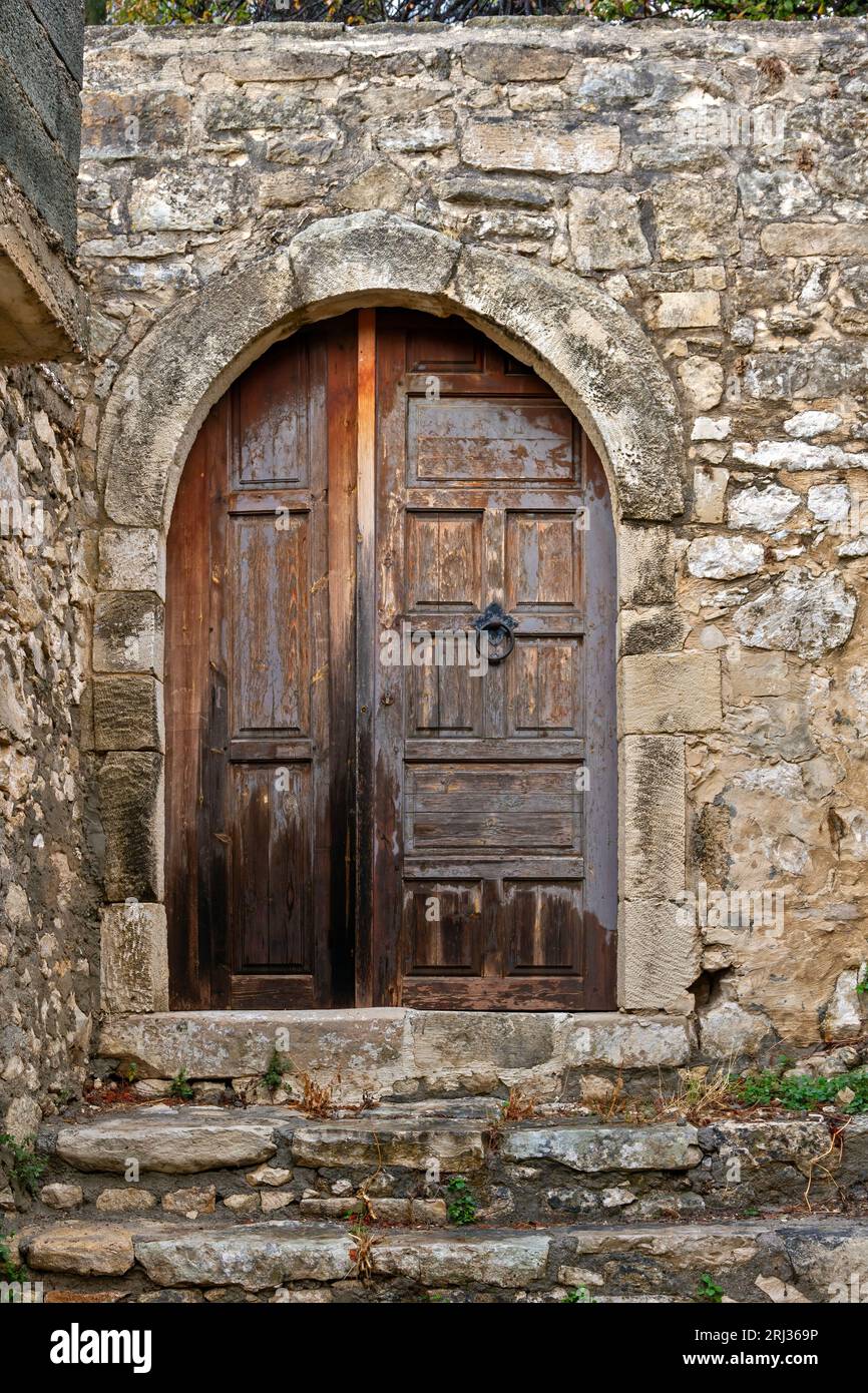 Old wooden door with stone arched lintel at an old mansion in Old Town ...