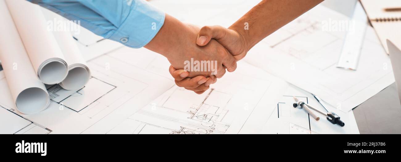 Construction engineer handshake with businessman contractor over ...