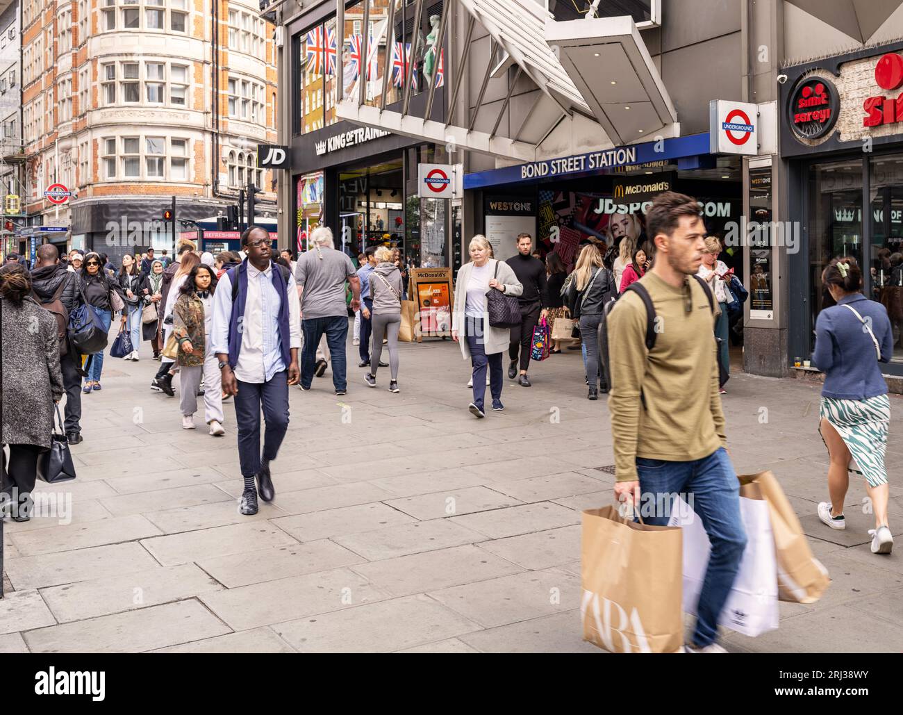 Passers-by on Oxford St, by Bond St Underground Station Stock Photo - Alamy