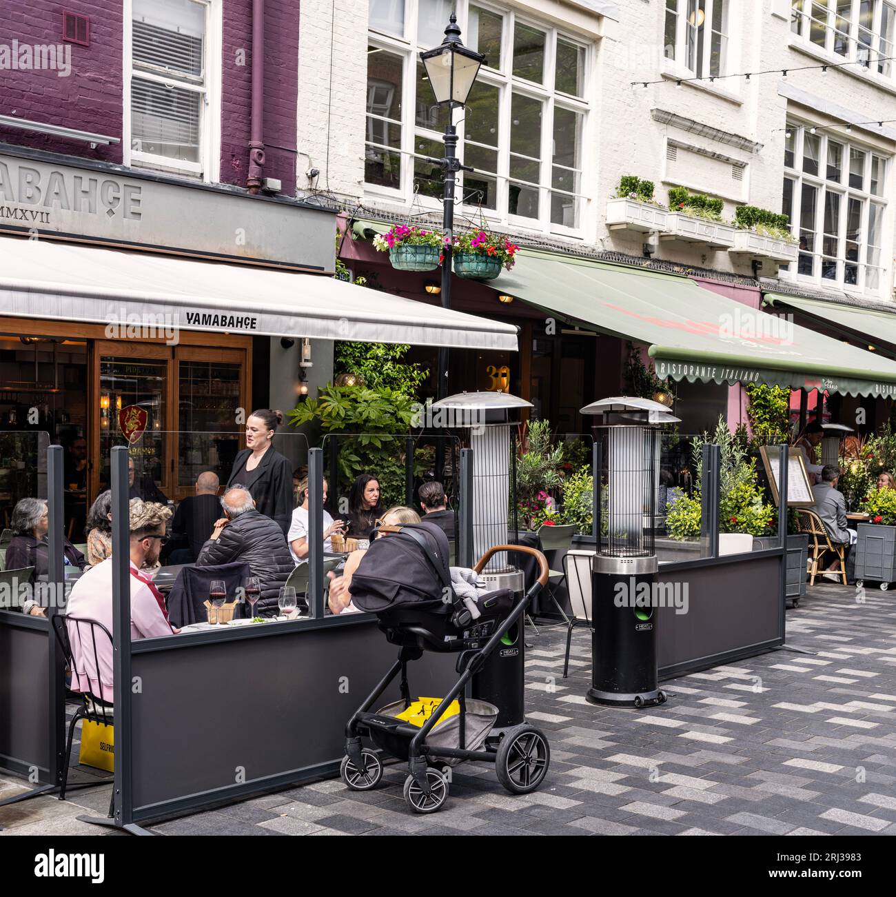 Restaurant with tables opening on to the street in central London, UK ...