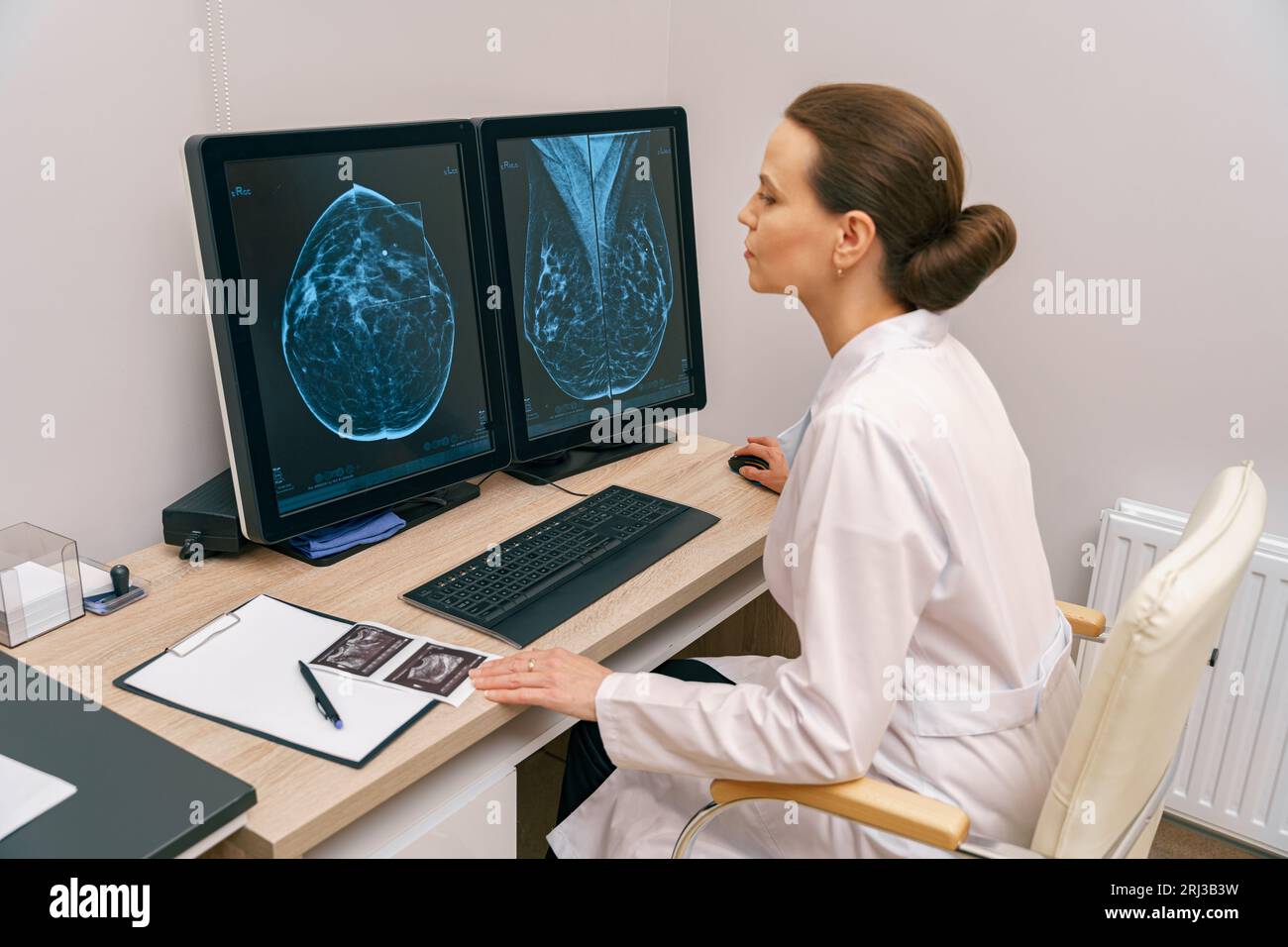 Professional doctor radiologist analyzing brain scan MRI images in ...