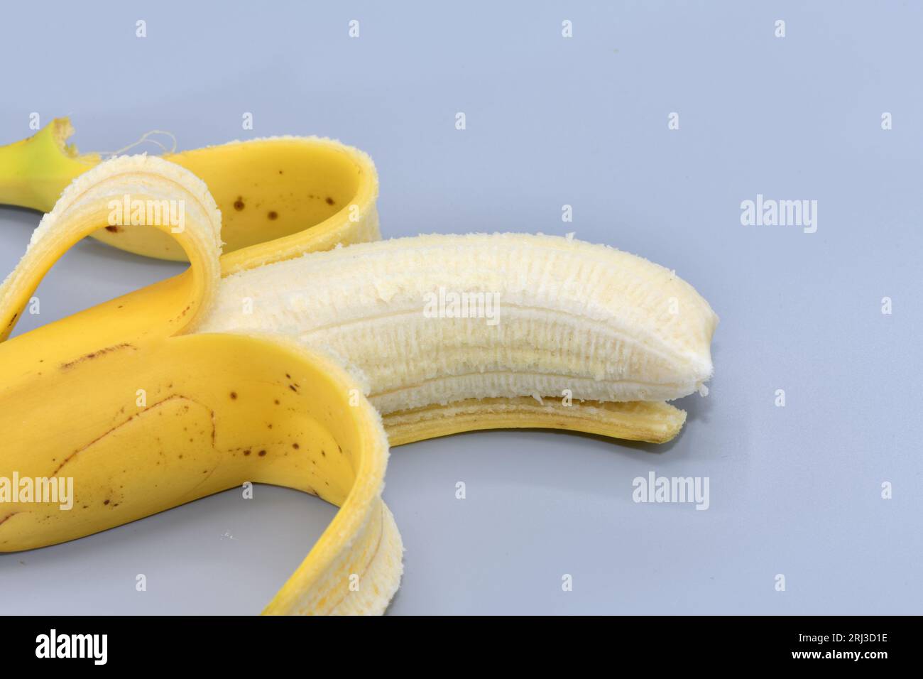 A peeled banana lying flat Stock Photo - Alamy