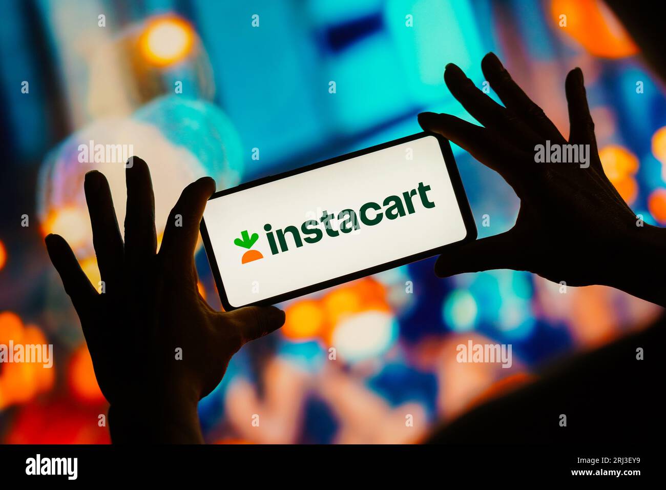 In this photo illustration, the Instacart logo seen displayed on a ...