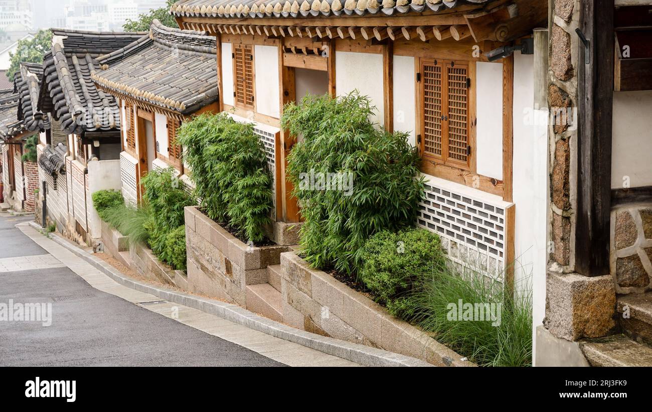 A stunning street view of a narrow alleyway, with white and tan ...
