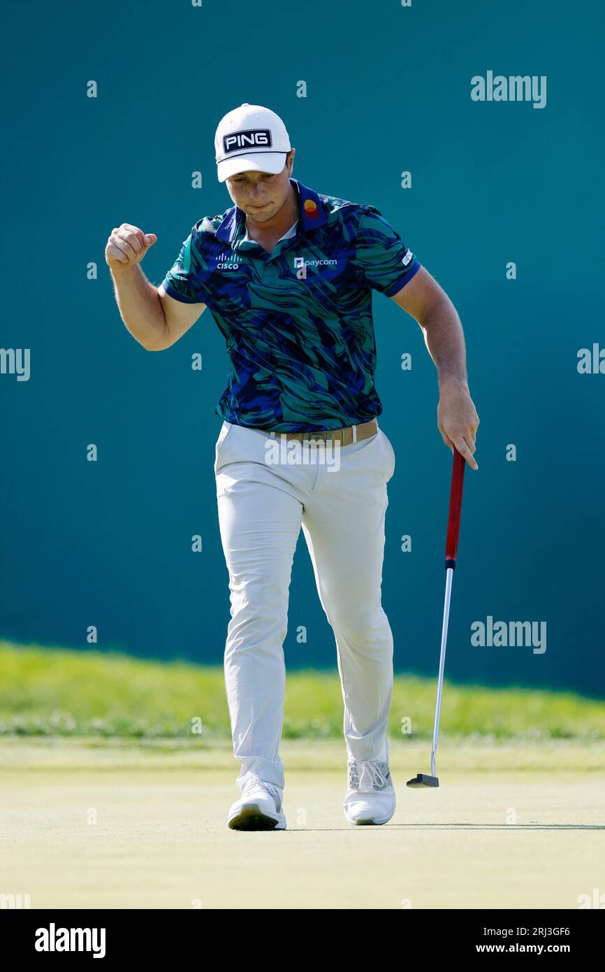 OLYMPIA FIELDS, IL - AUGUST 20: Viktor Hovland of Norway reacts after holing a birdie putt at ...