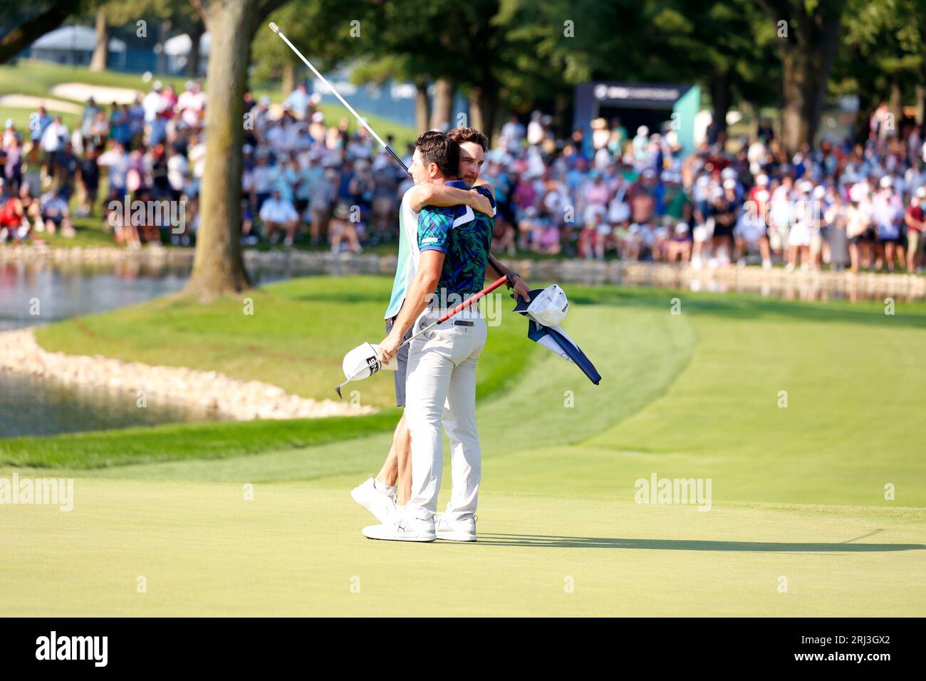 OLYMPIA FIELDS, IL - AUGUST 20: PGA golfer Viktor Hovland is congratulated by his caddie Shay ...