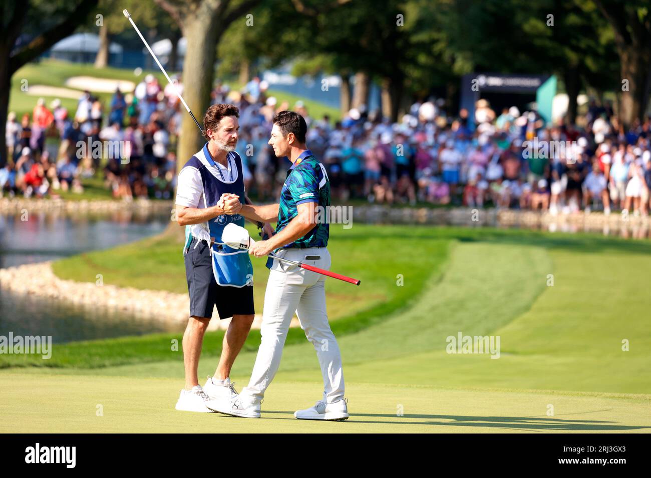 OLYMPIA FIELDS, IL - AUGUST 20: PGA golfer Viktor Hovland is congratulated by his caddie Shay ...