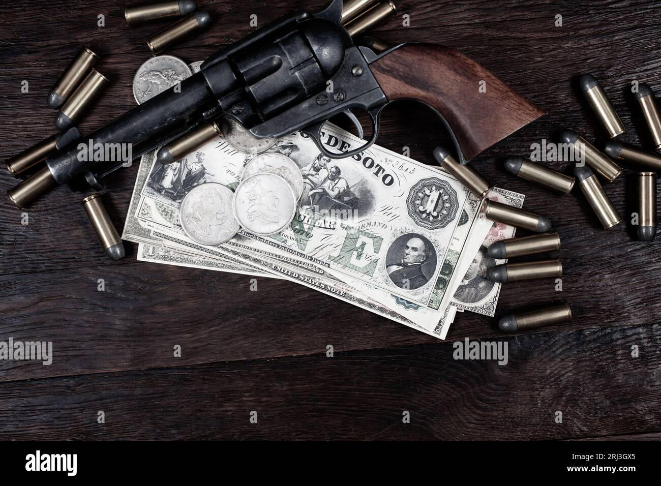 Old west Colt Peacemaker and US banknotes and silver certificates with ...