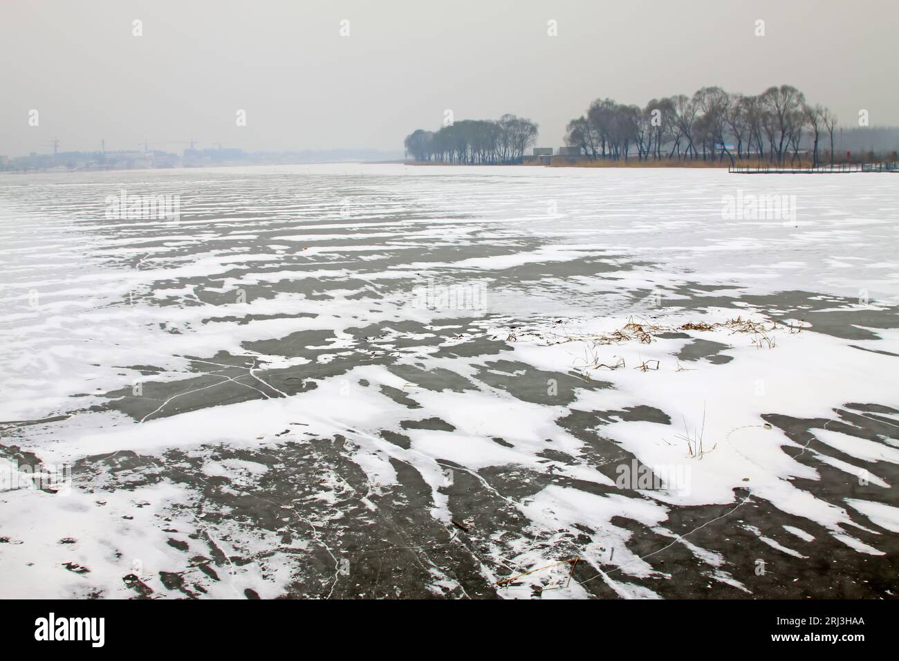 river's natural landscape after snow in a park in winter, north china ...