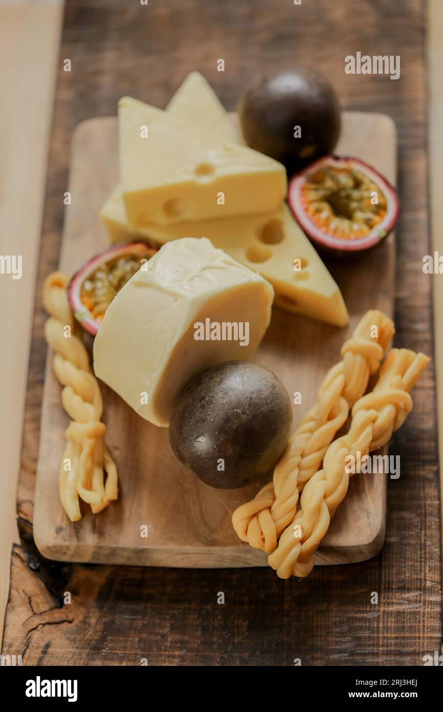 Cheese platter with fruits. assorted cheese on a wooden board with ...