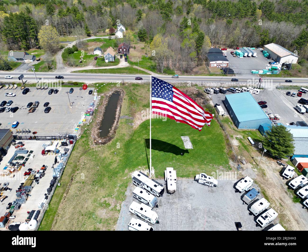 An aerial shot of a parking lot with an American flag waving in the ...
