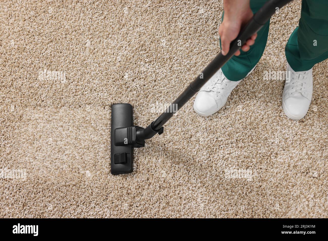 Dry cleaners employee hoovering hi-res stock photography and images - Alamy