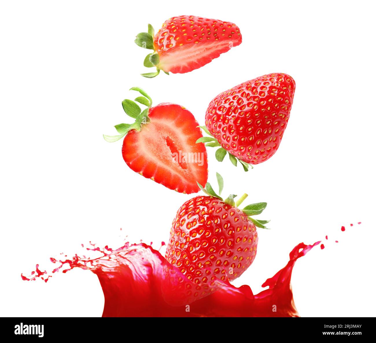Strawberries falling into juice on white background Stock Photo - Alamy