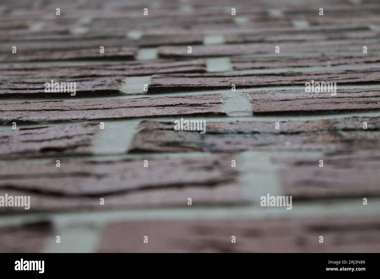 This image captures the bottom view of an old brick building ...