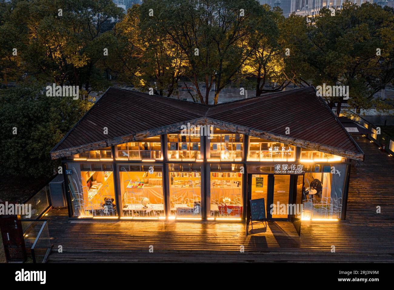 A traditional two-story house with a wooden deck, situated in a natural ...