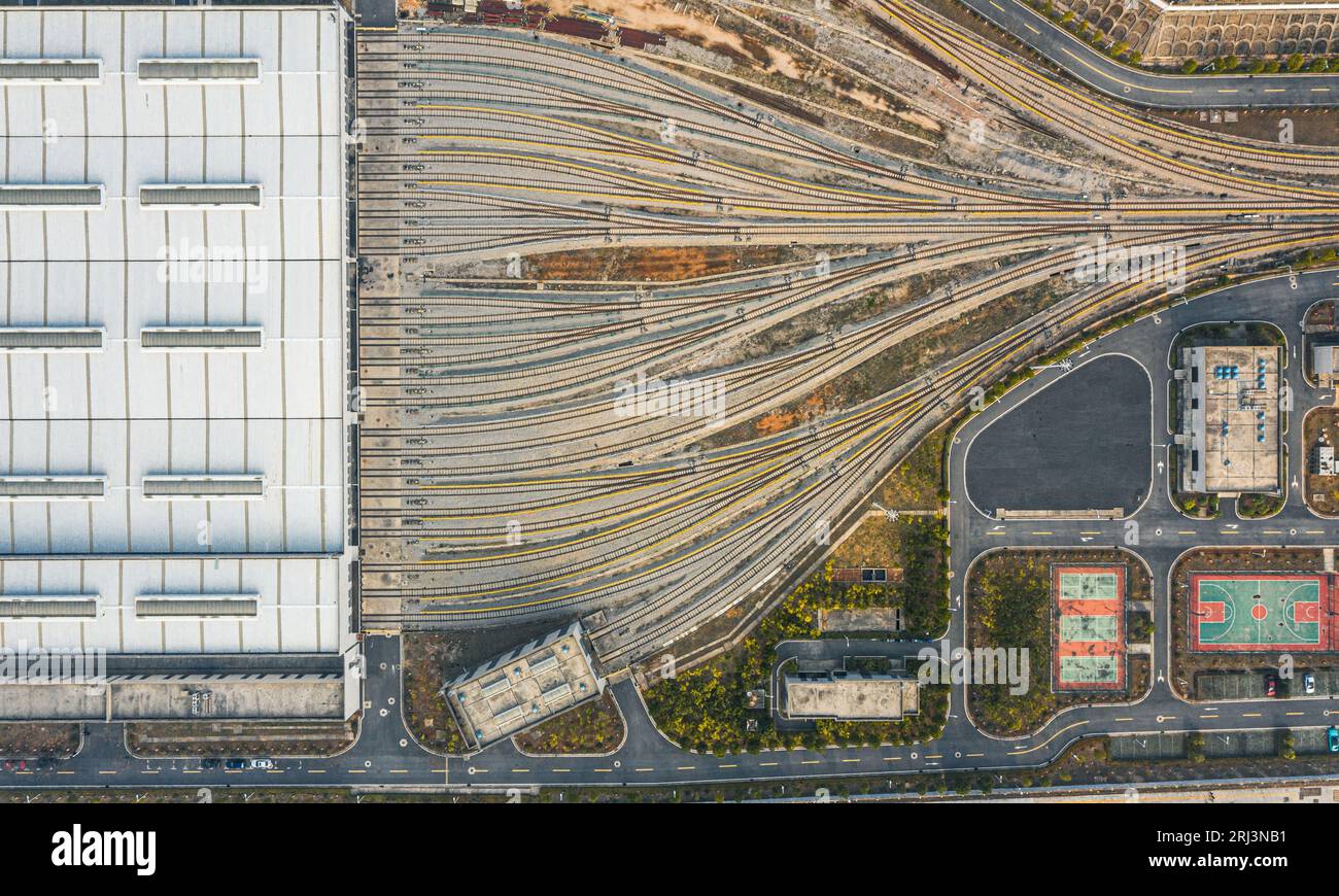 An aerial view of a vibrant cityscape featuring numerous railroad ...