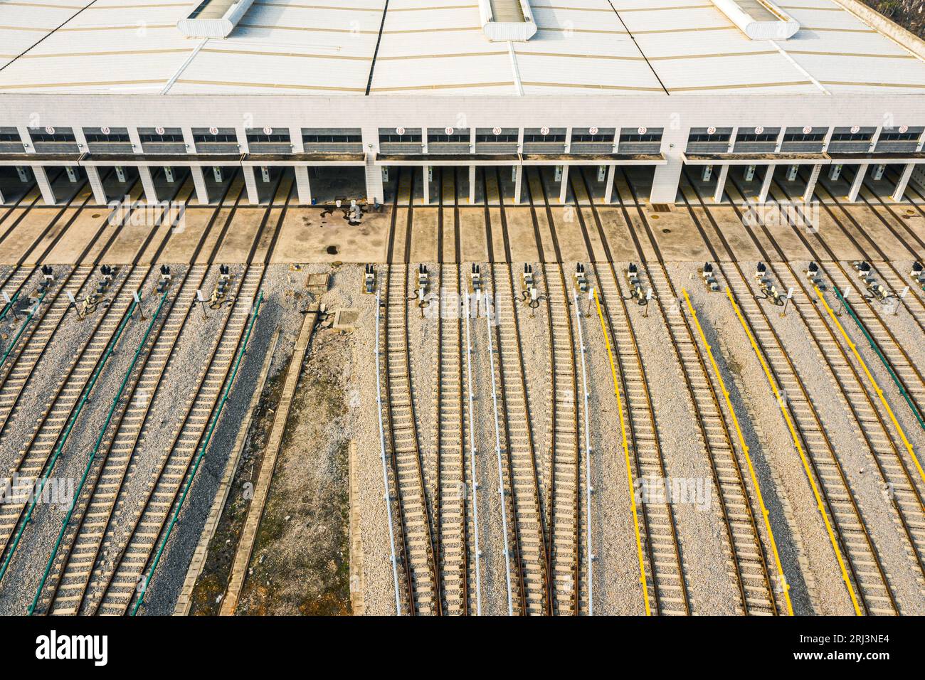 An aerial view of a vibrant cityscape featuring numerous railroad ...