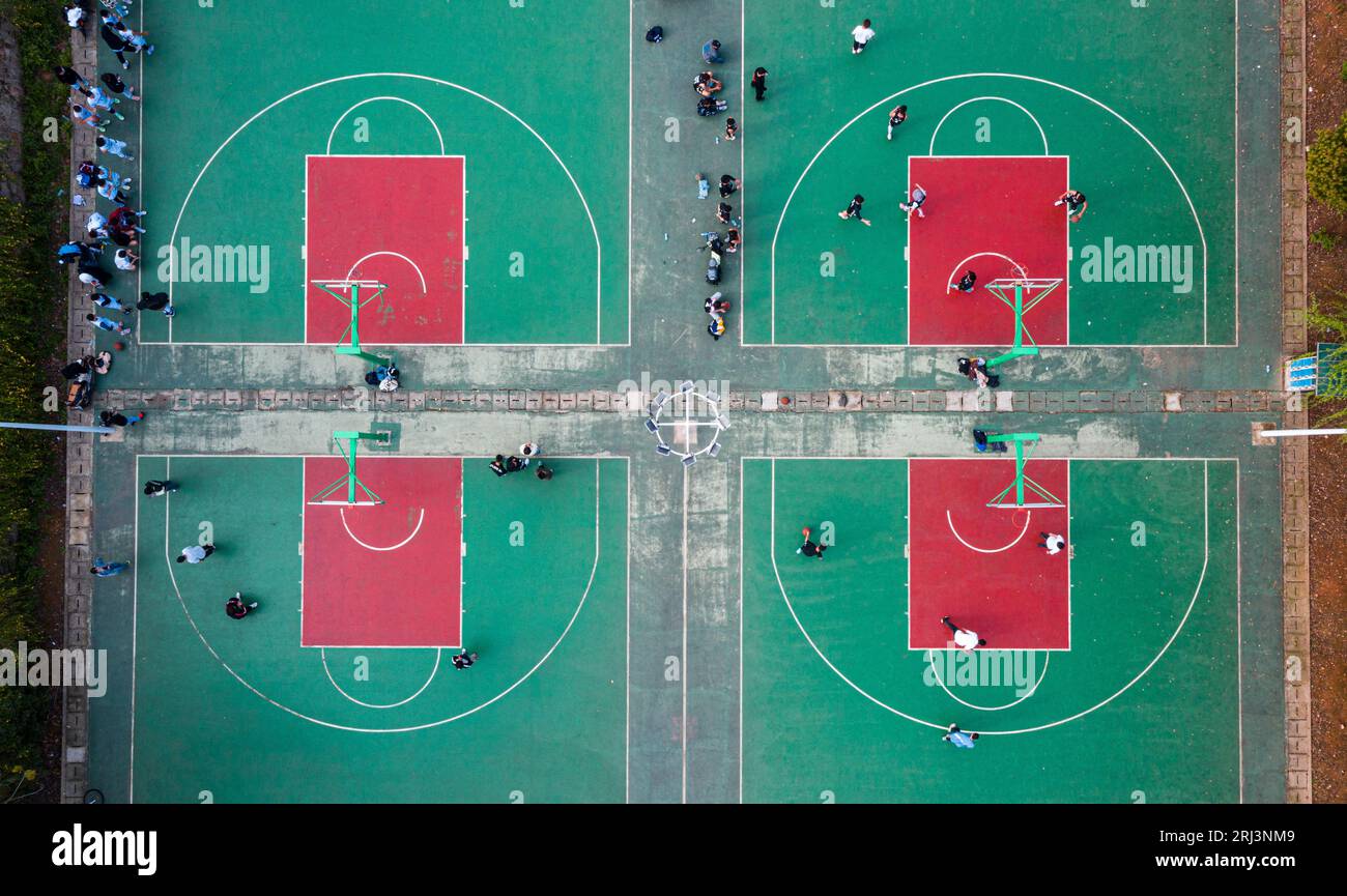 An aerial view of an outdoor court with a group of people playing ...