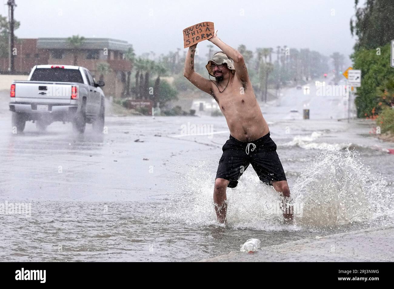 Joseph Wolensky stands in the street with a sign that says "You call ...