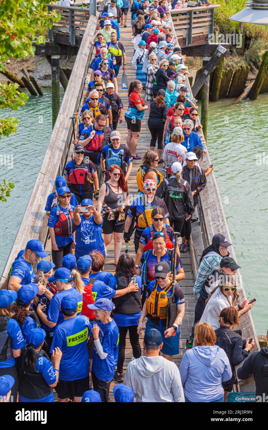 Dragon Boat teams crossing a bridge at the Richmond Festival in Canada ...