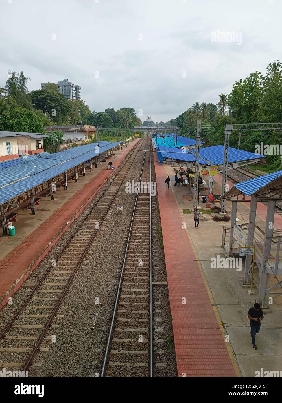 A bustling train station with two lines of tracks running side by side ...