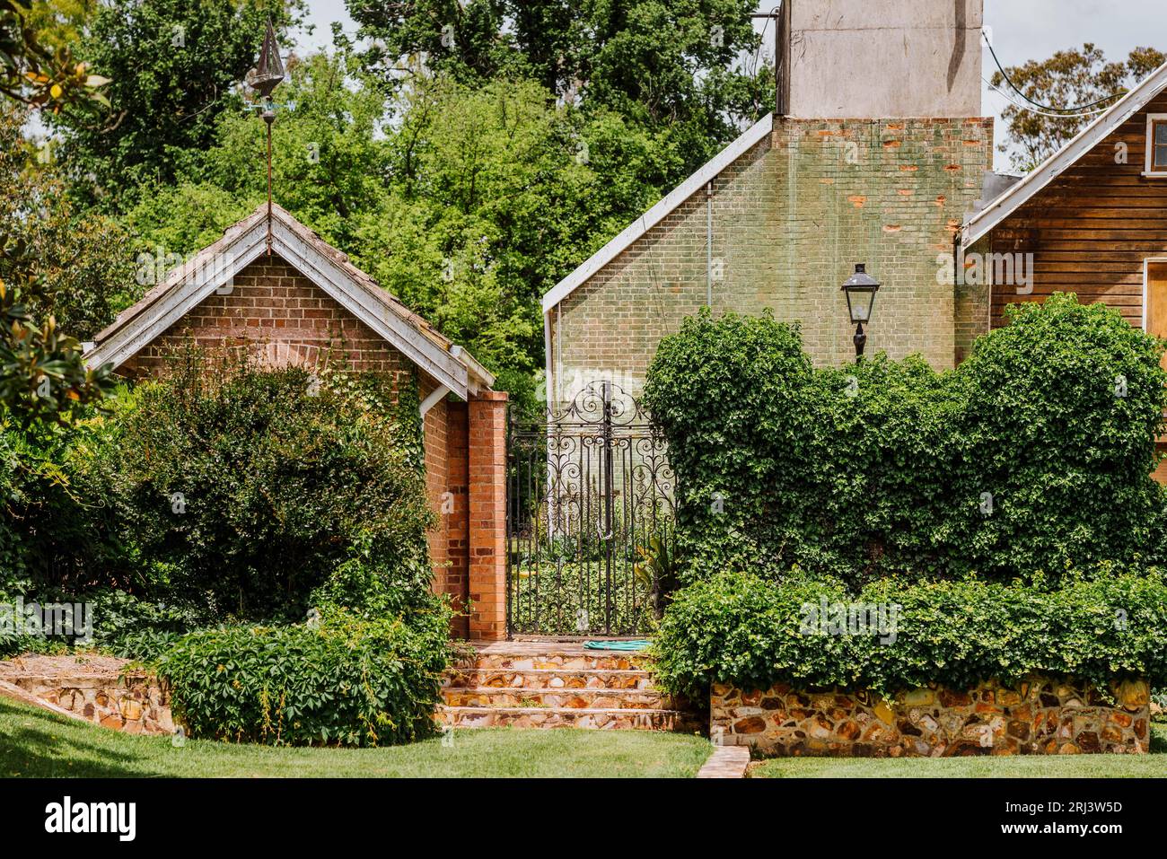 A two story house quaint house surrounded by lush green trees in the ...