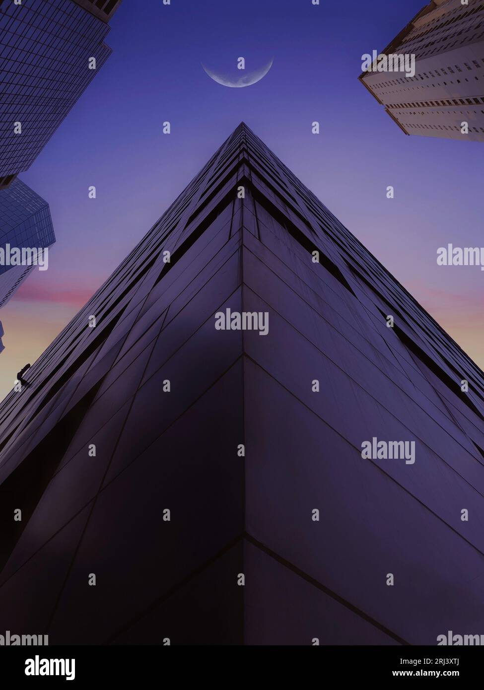 A glowing full moon illuminates the night sky above a metropolitan ...