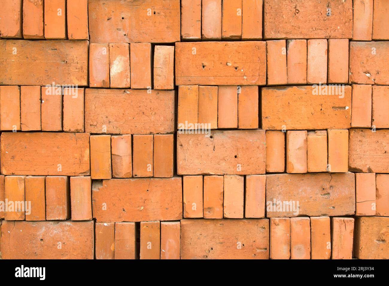 piled up of red bricks in a construction site Stock Photo - Alamy