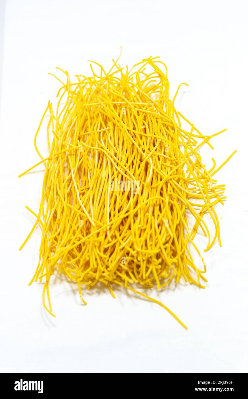 A close-up Raw Shell Shaped Pasta with a white background Stock Photo ...