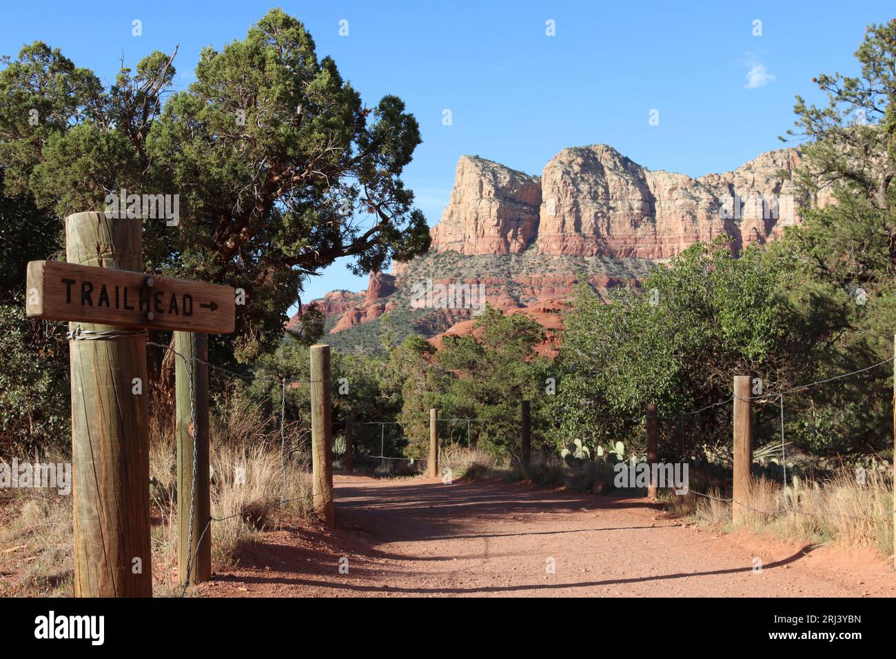 A scenic road with a directional sign labeled Trail road on either side ...