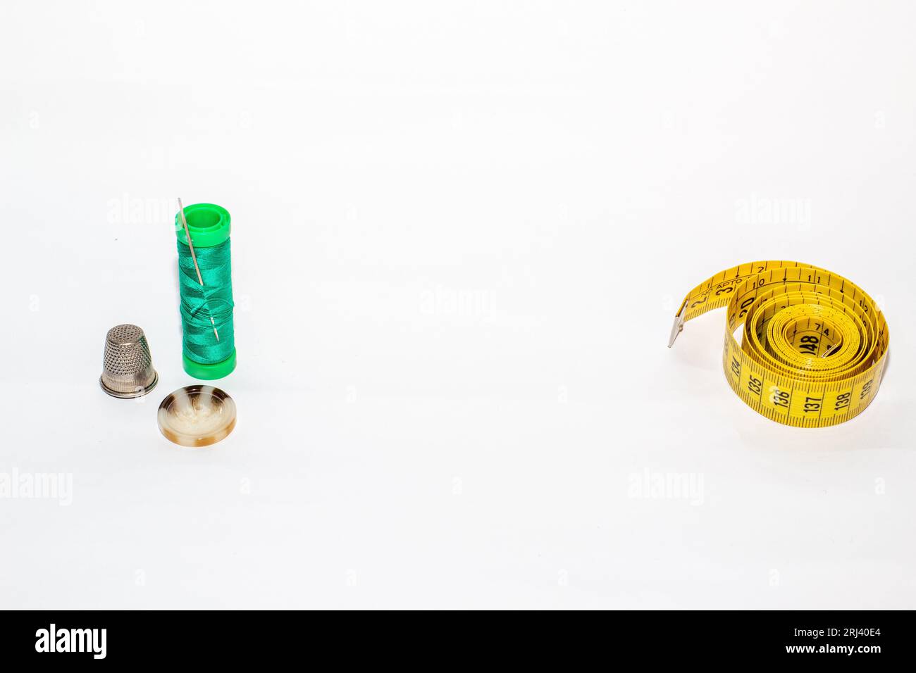 A ruler is placed beside a small, colorful cat toy and two metal balls ...