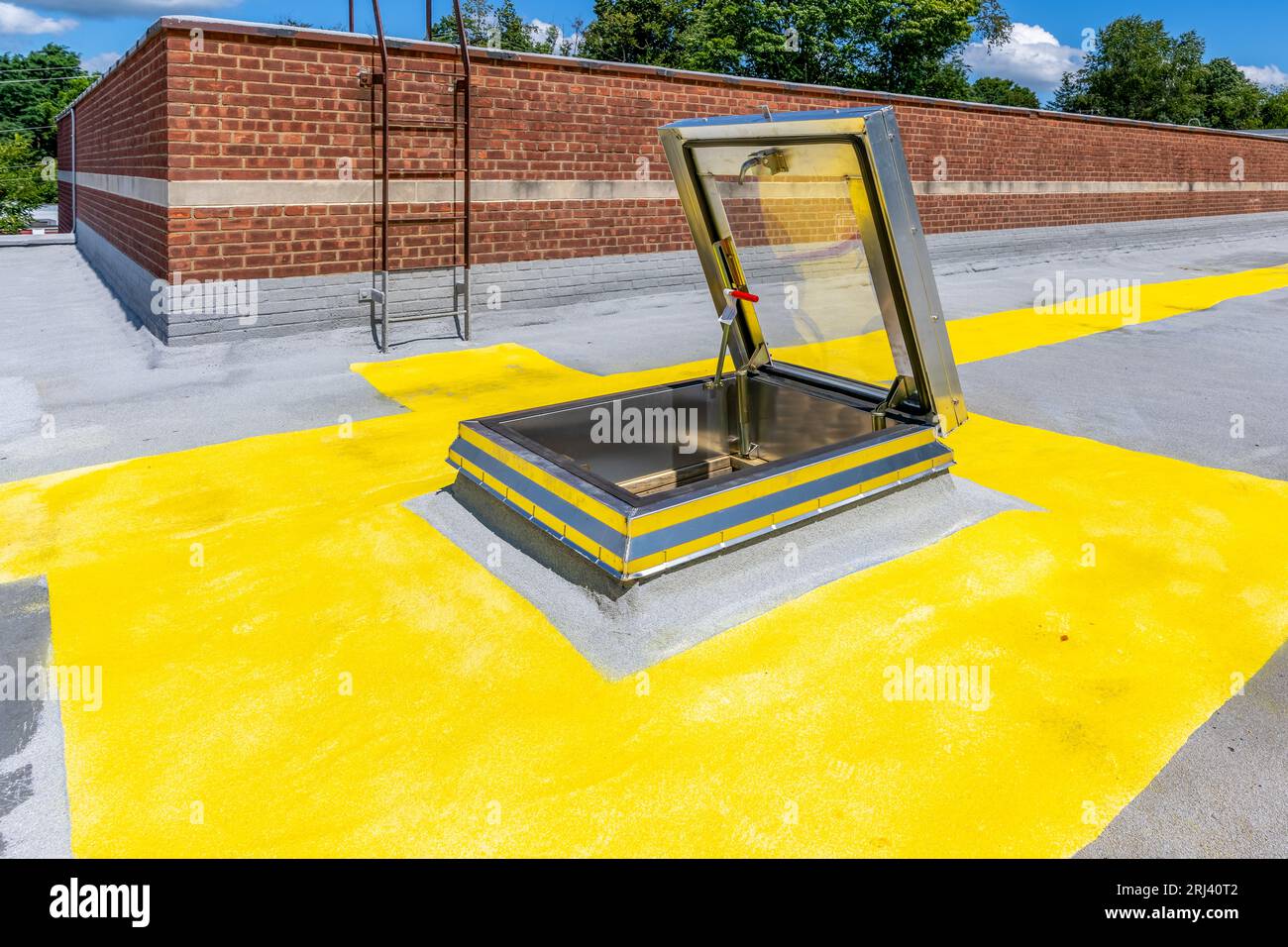 Roof hatch for access to roof with a built in skylight on a spray foam ...