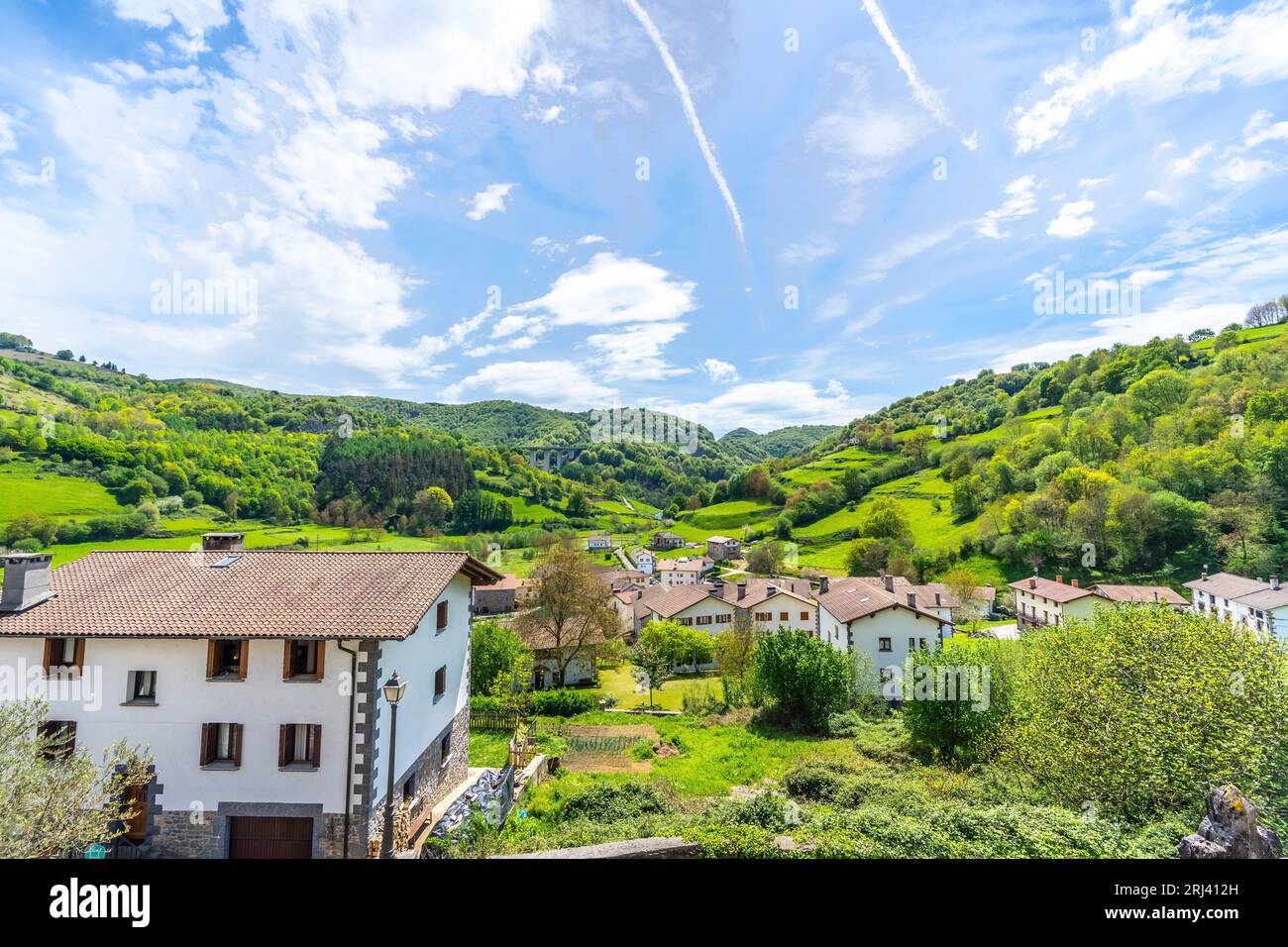 Typical white buildings surrounded by greenery in Areso, Sierra de ...