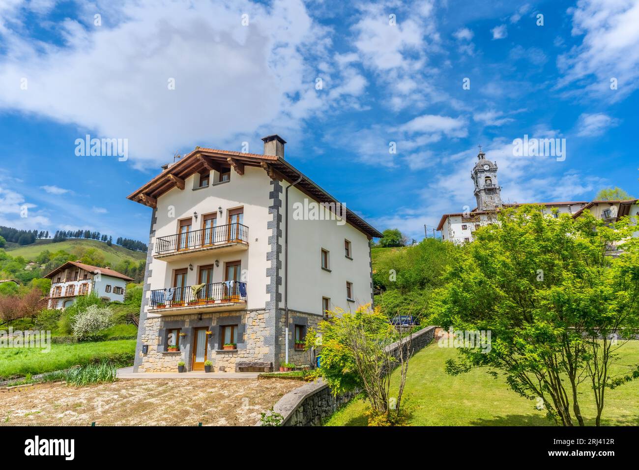 Typical white buildings surrounded by greenery in Areso, Sierra de ...