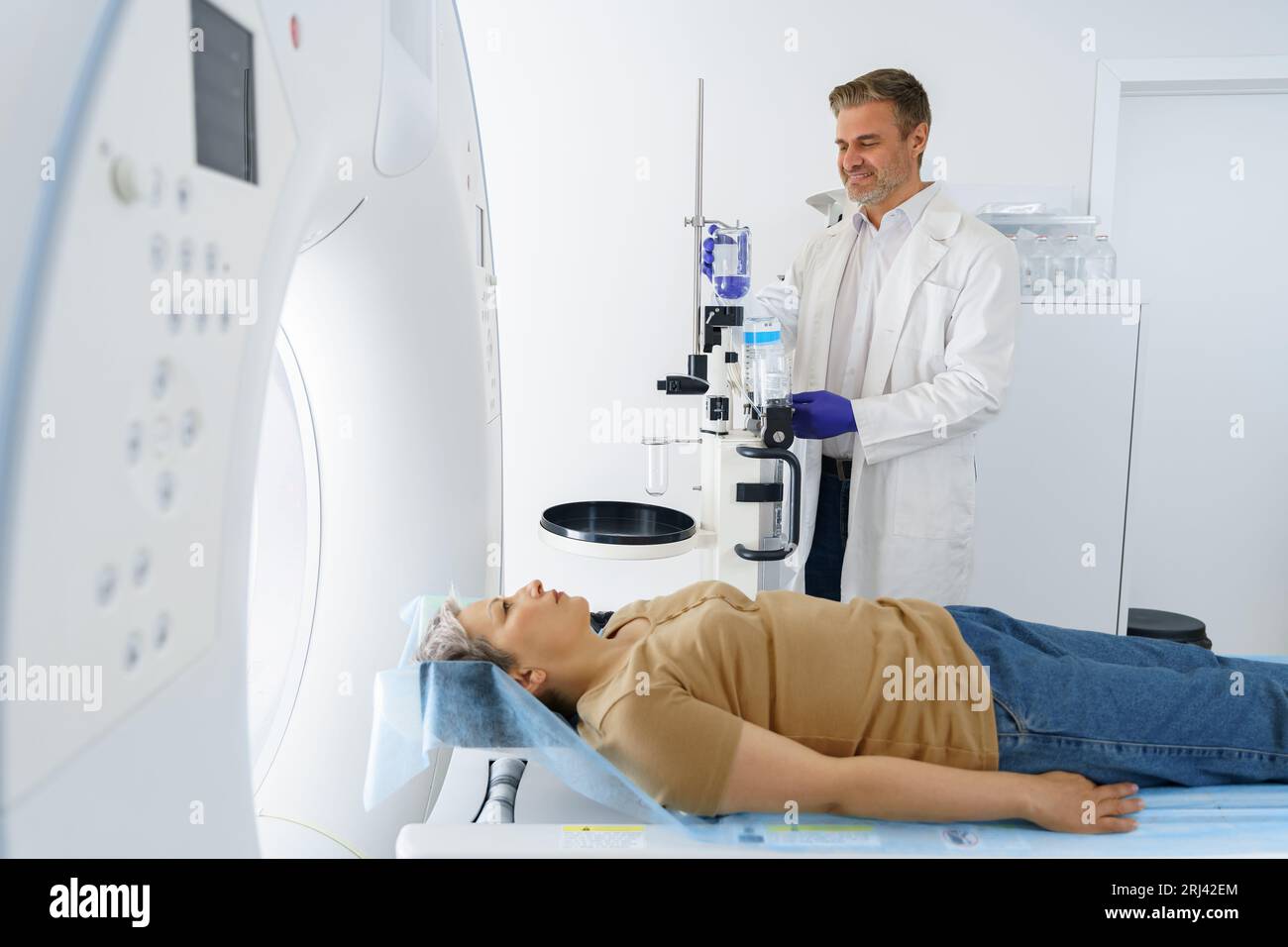Doctor and female patient in the room of computed tomography at ...