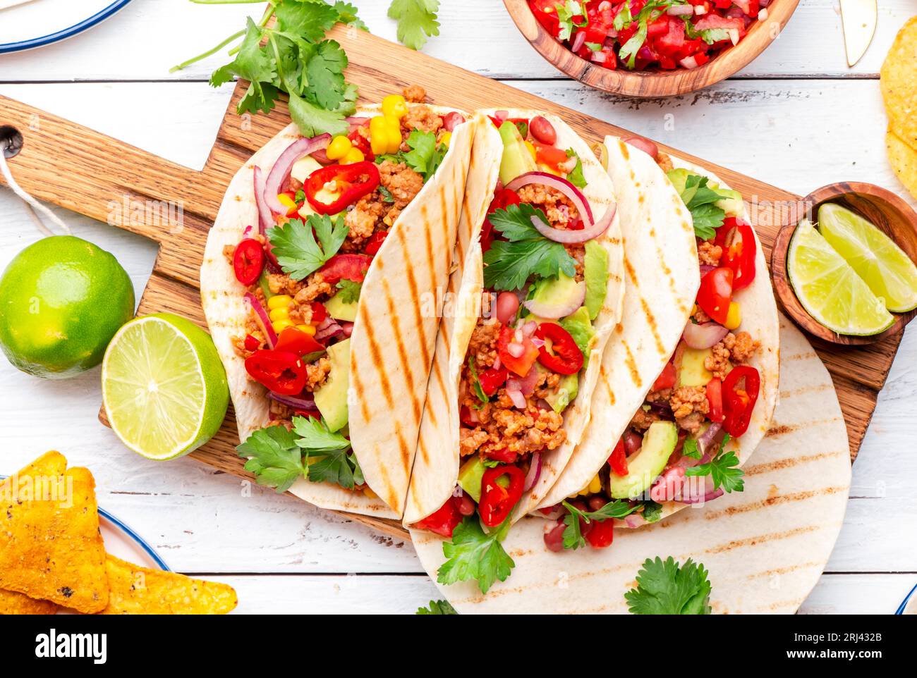 Mexican cuisine. Tacos with beef, corn, red beans, tomato salsa sauce ...