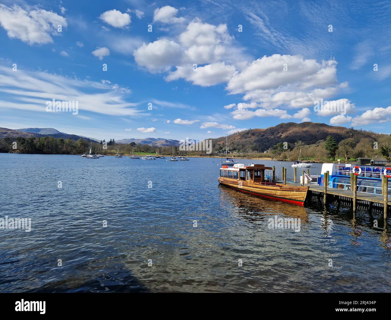 Multiple boats neatly docked at a marina, situated on a calm body of ...