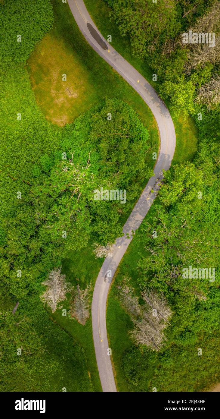 An aerial view of a winding road through a grassy landscape Stock Photo ...