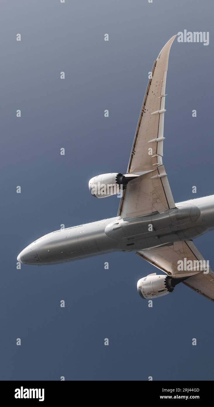 An aerial view of a jet plane soaring across a bright blue sky Stock ...