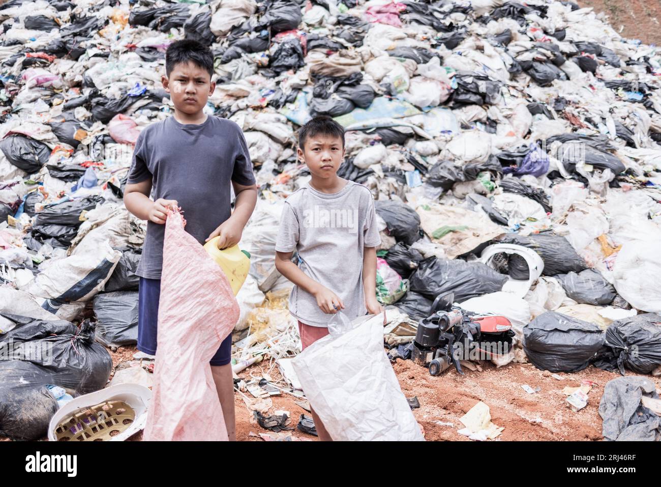 Poor boy collecting garbage in his sack to earn his livelihood, The ...