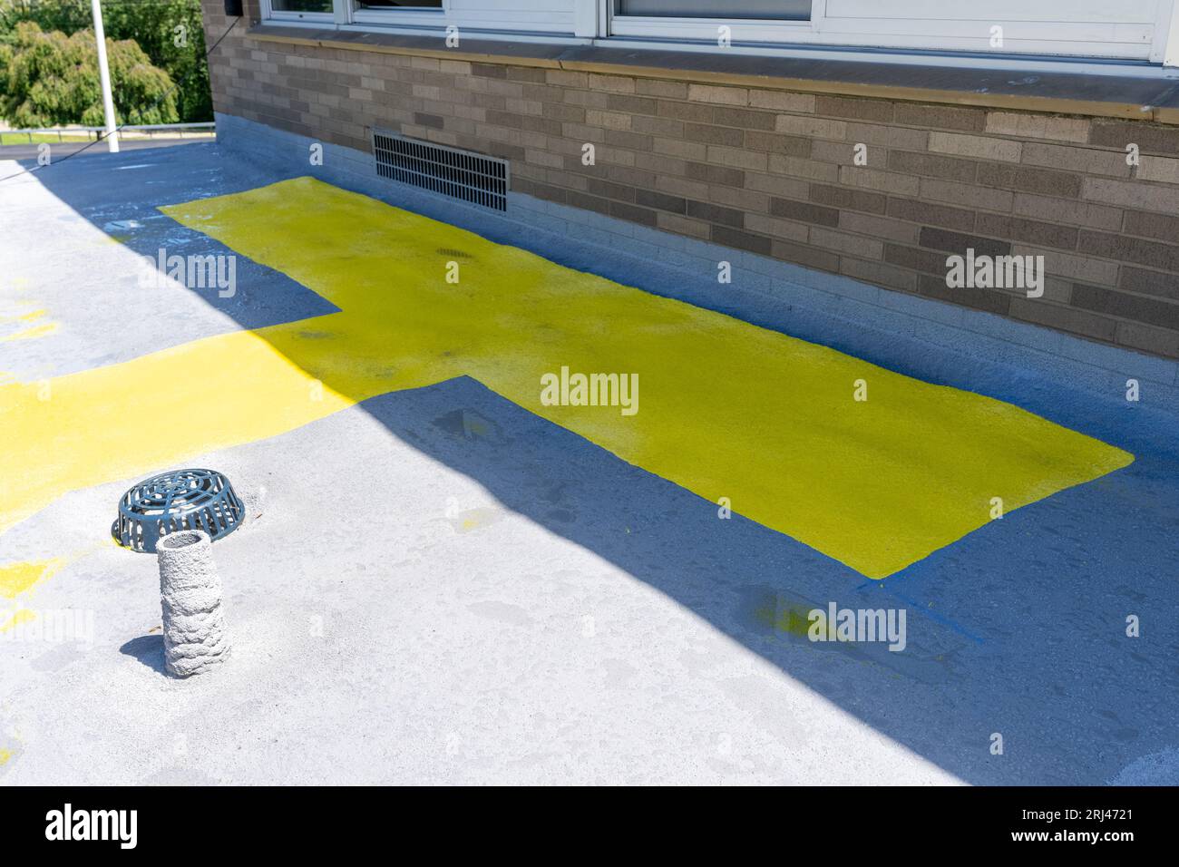 Painted safety yellow walkway on new spray foam roof for foot traffic ...