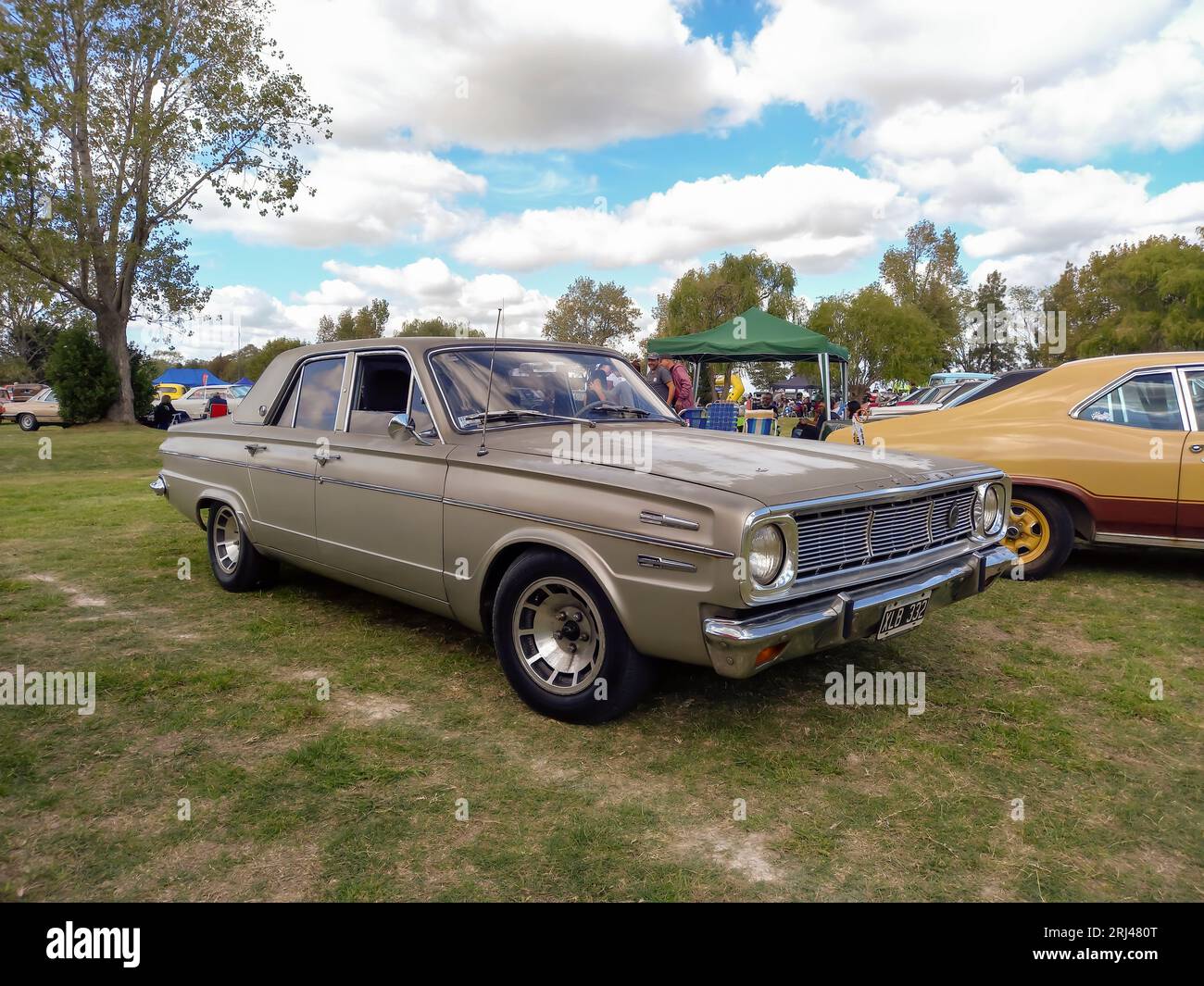 An old 1960s Chrysler Valiant IV four-door sedan parked on green lawn ...