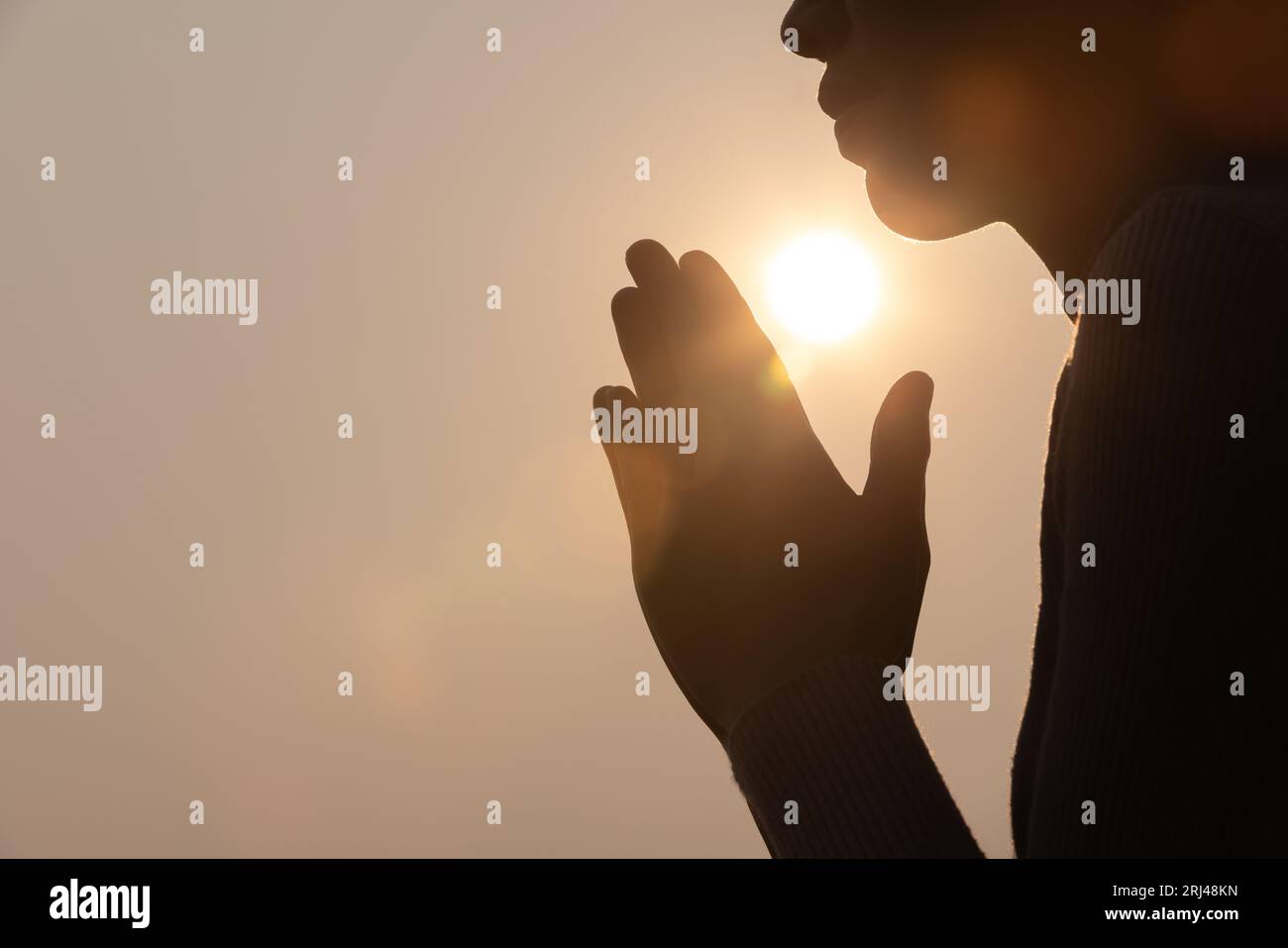 Silhouette of woman prayer position, Praying hands with faith in ...