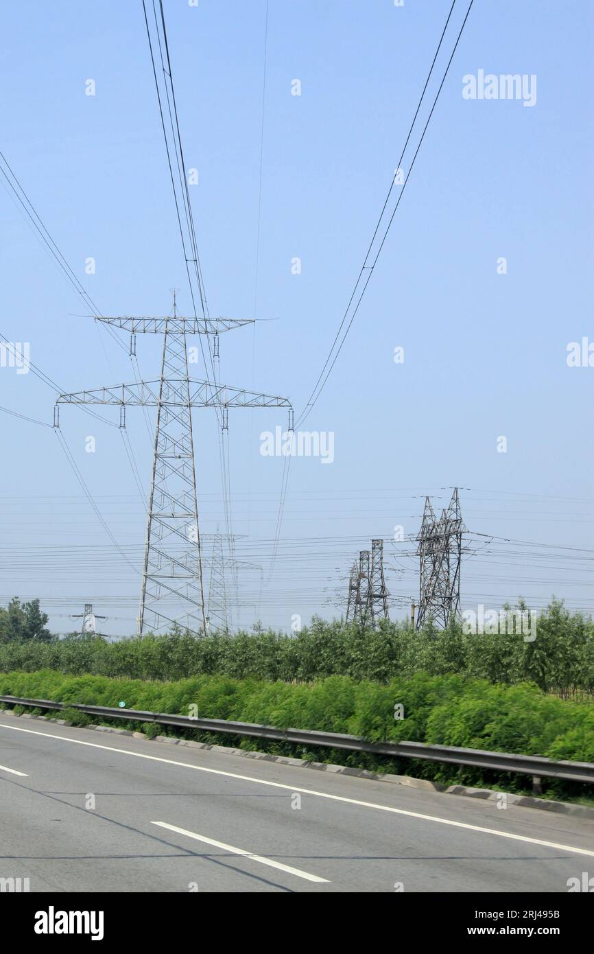High voltage power transmission lines in the side of the freeway Stock ...