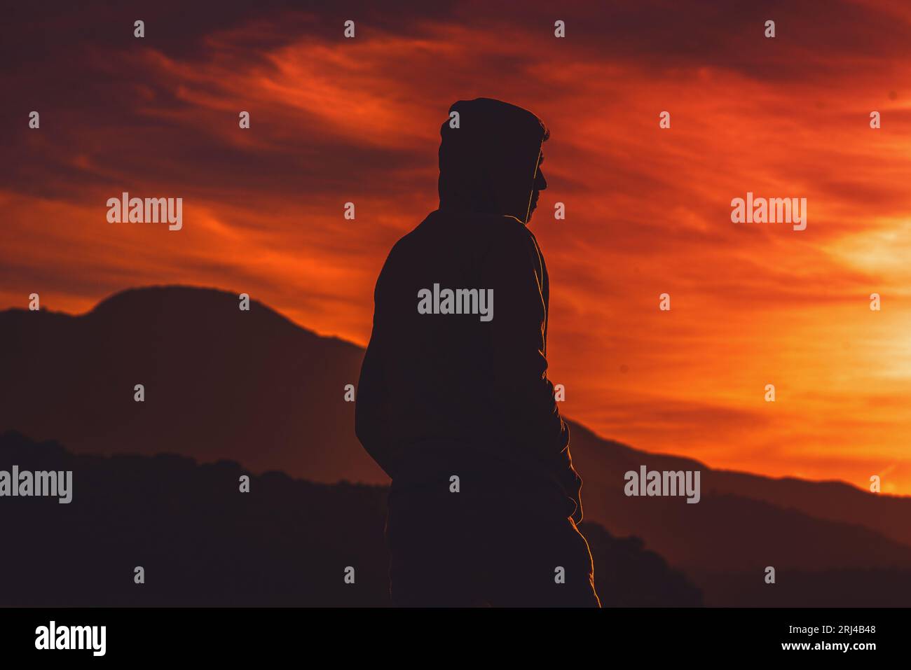 Silhouette of young boy at sunset Stock Photo - Alamy