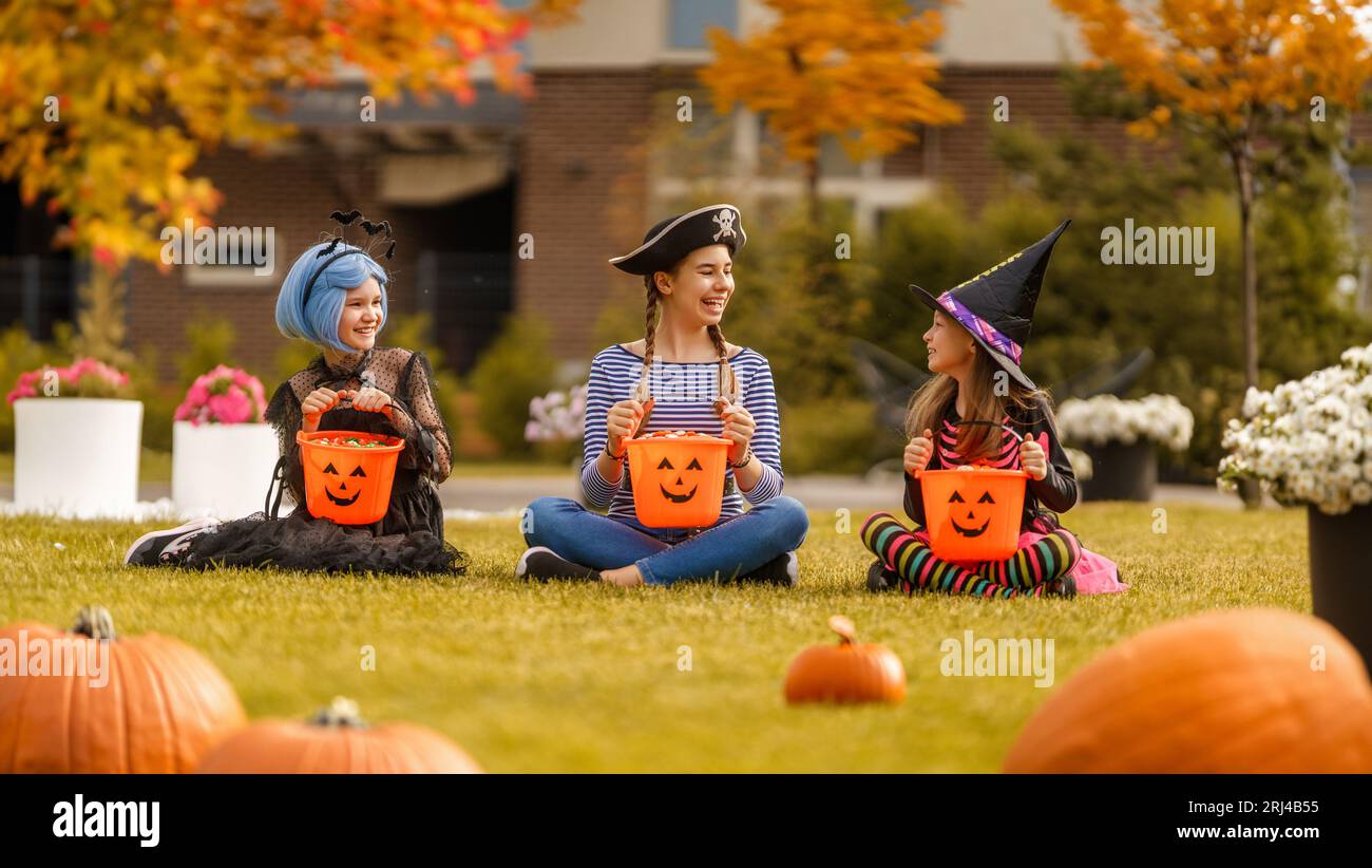 Happy kids at Halloween party. Children are wearing carnival costumes ...